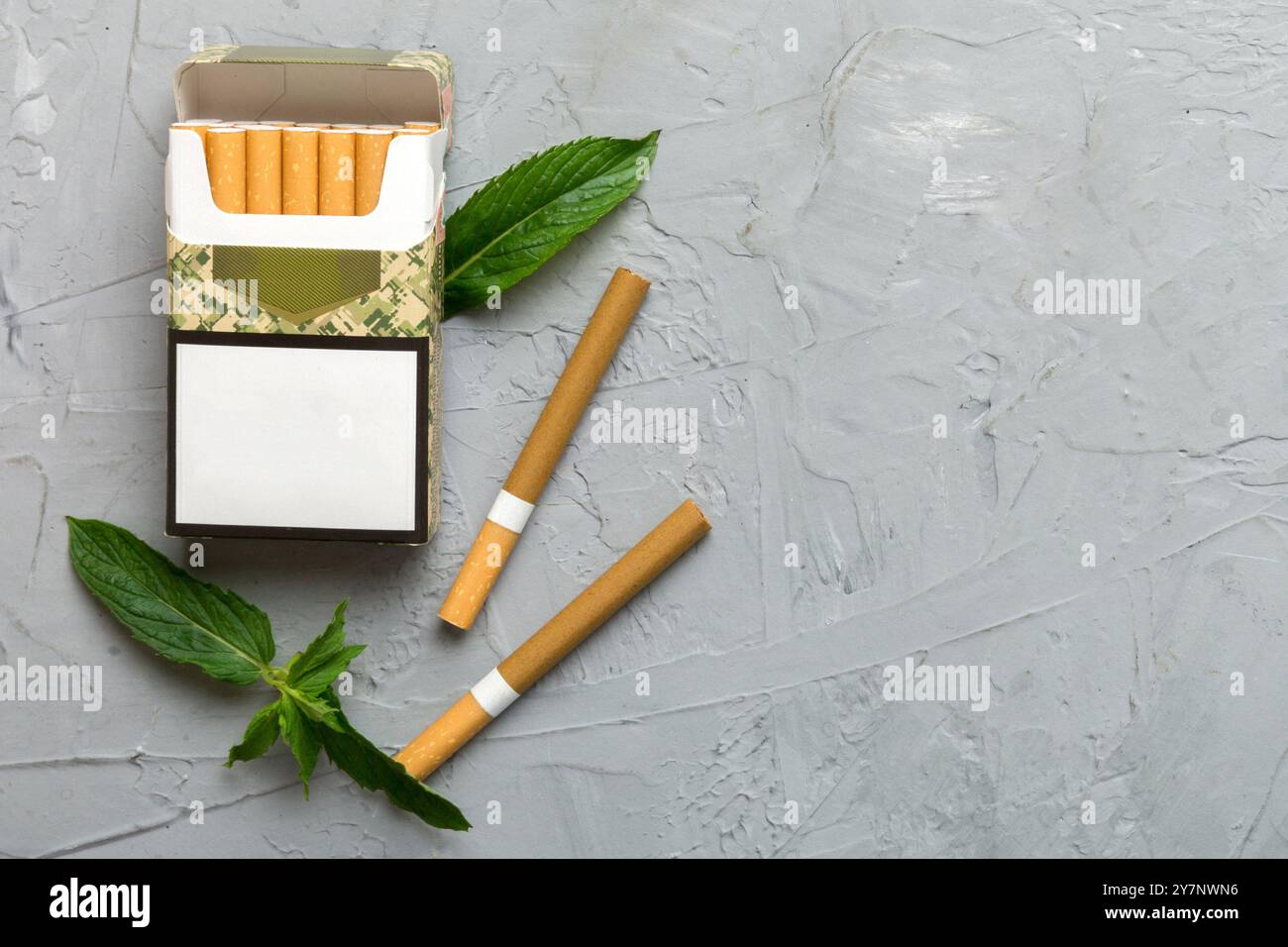 Pack of menthol cigarettes and fresh mint on colored table, Menthol ...