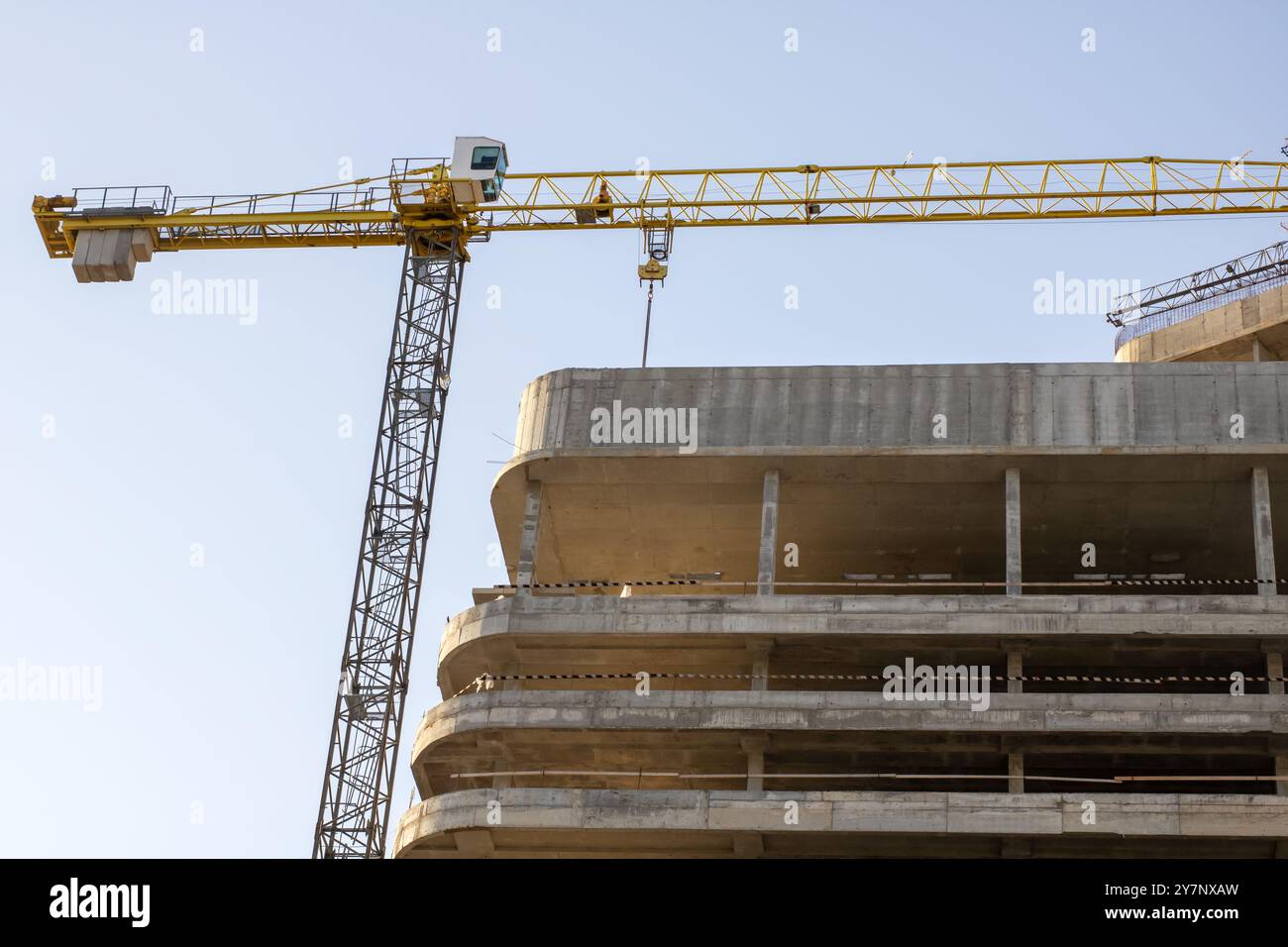 A bustling construction site featuring several cranes in action, and a ...