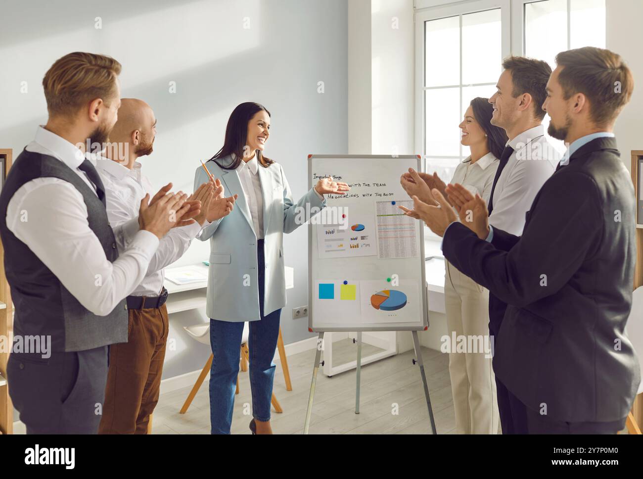 Office Team Celebrating Colleague Success Stock Photo - Alamy