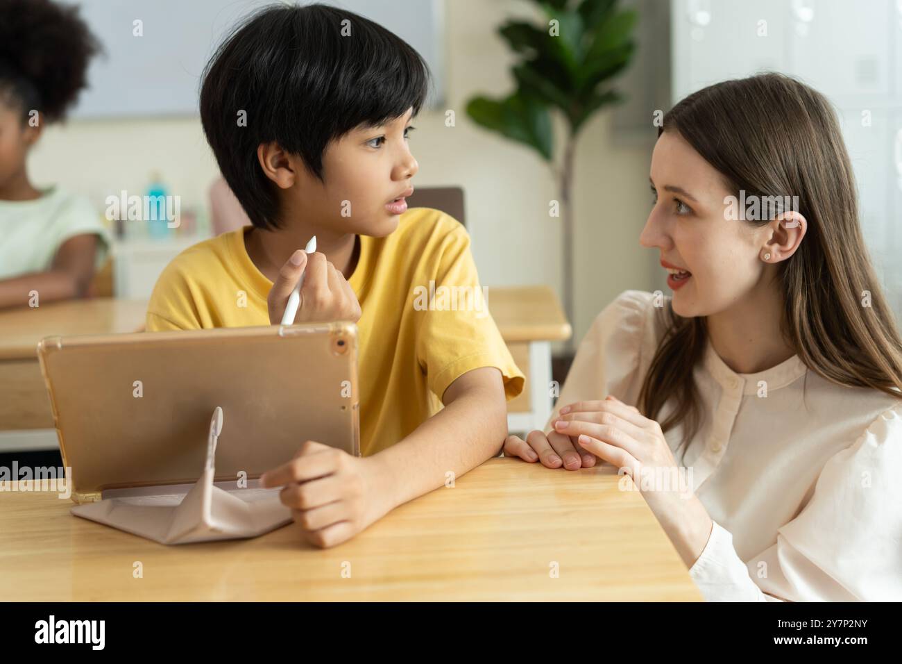 Teacher Guiding Student with Digital Learning in Diverse Classroom ...