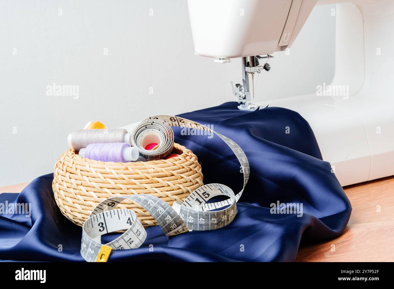 Sewing tools and materials arranged on fabric with a sewing machine in ...