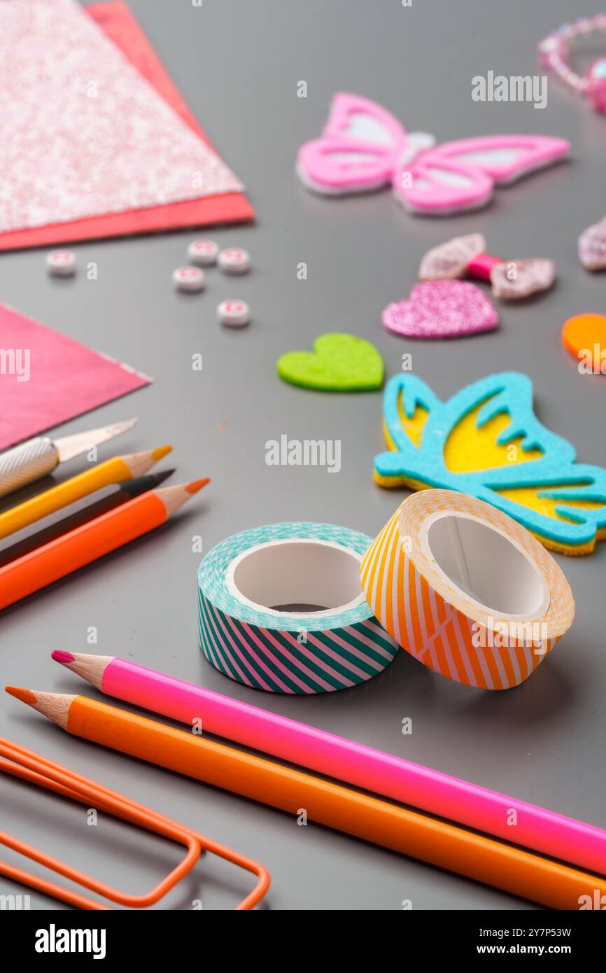 Crafting materials and tools arranged on a gray surface during a ...