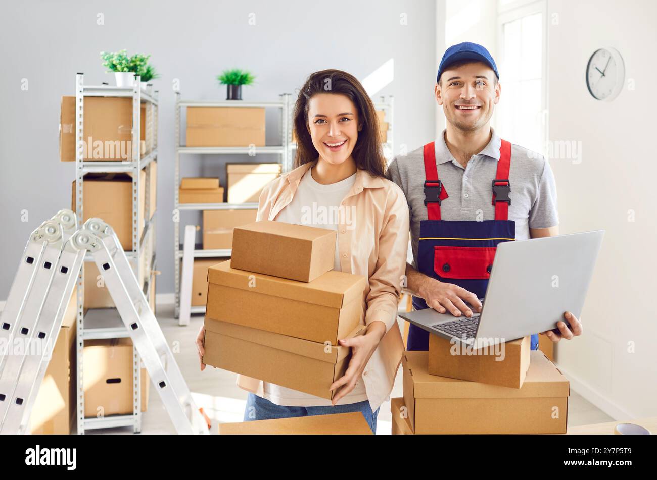 Woman with man worker from delivery service standing at workplace in ...