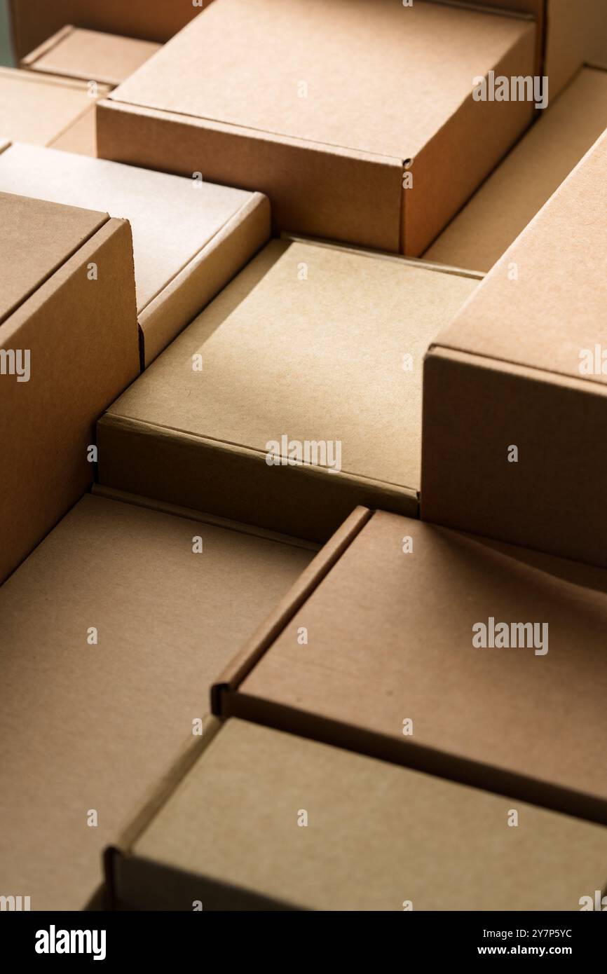 Stacked cardboard boxes arranged in a neat pattern under natural light ...