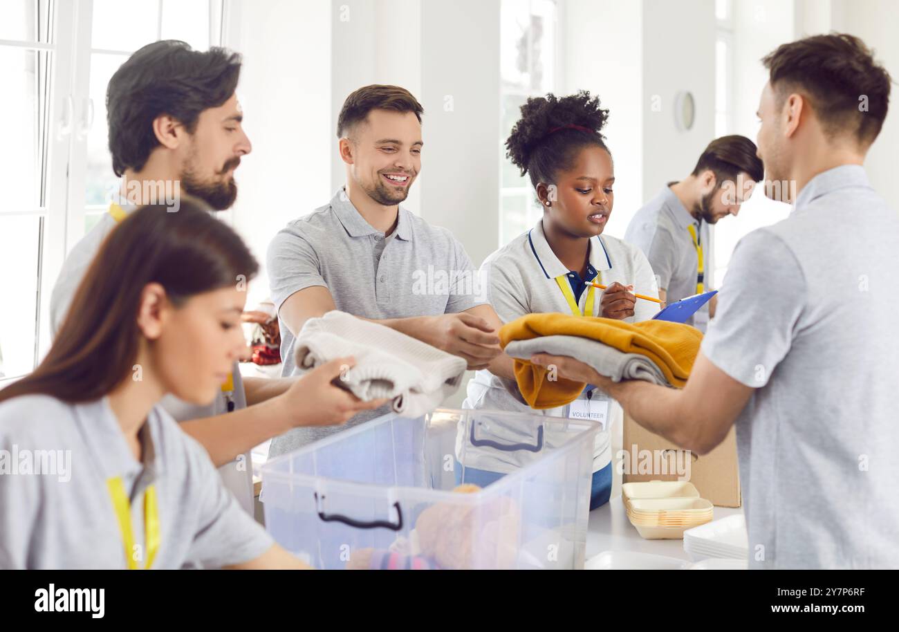 Volunteer Team Packing Food And Items Into Boxes Stock Photo - Alamy