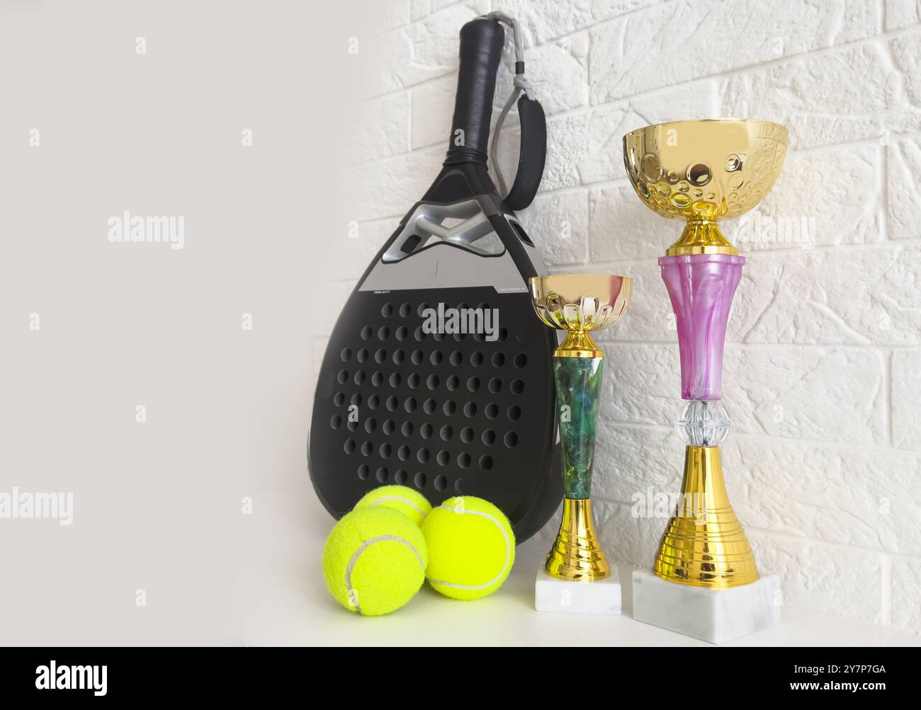Golden trophy and padel racket. sport achievement, success concept ...