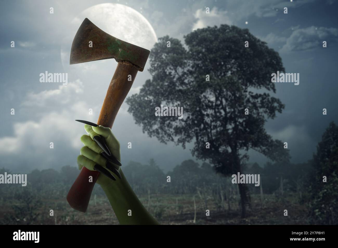 Witch hand with long black nail holding axe in with full moon in the ...