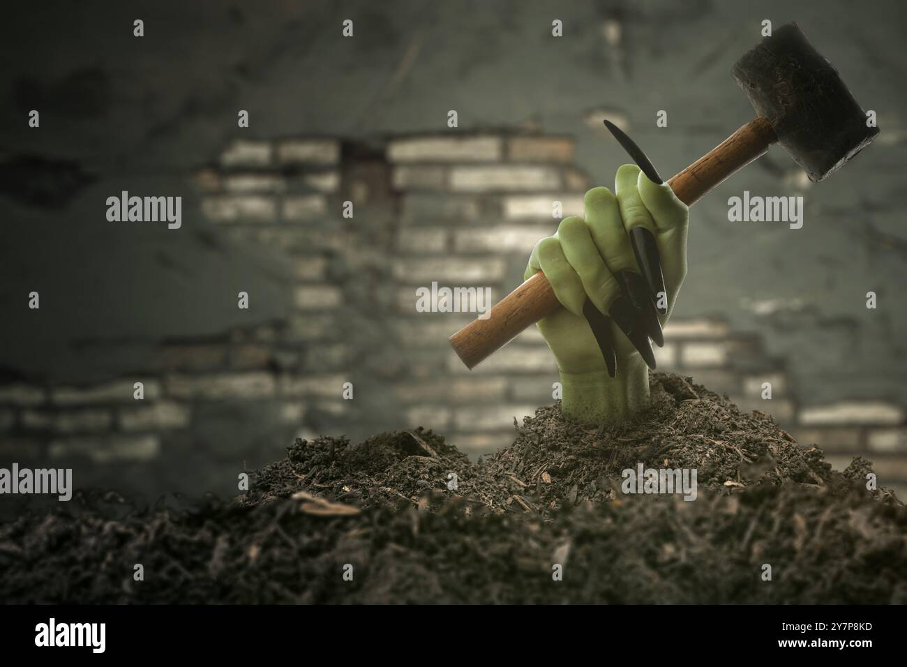 Witch hand with long black nail coming out from grave ground holding a ...
