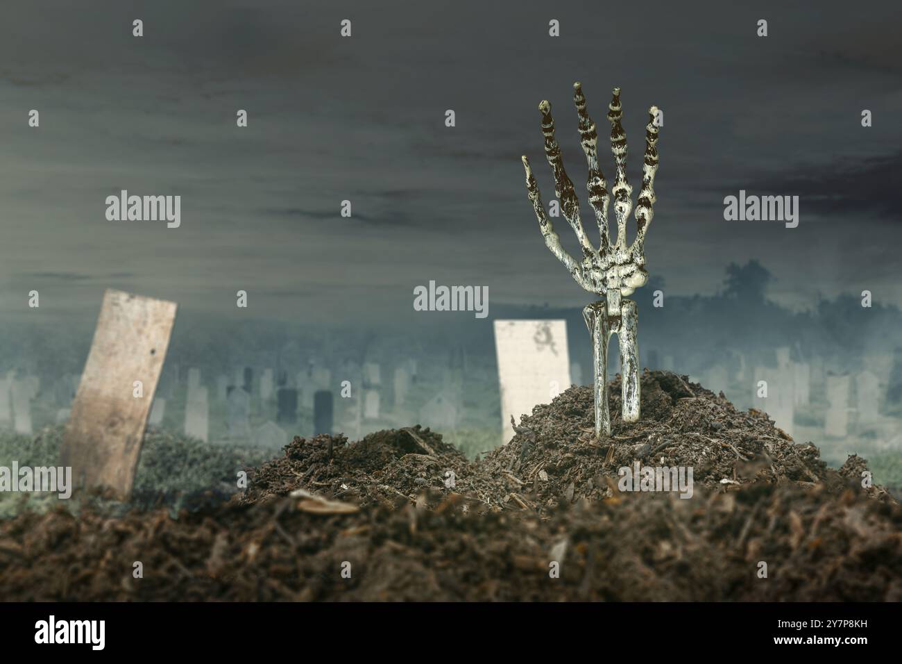 Human skeleton hand rising out of graveyard ground, with a creepy, dark ...
