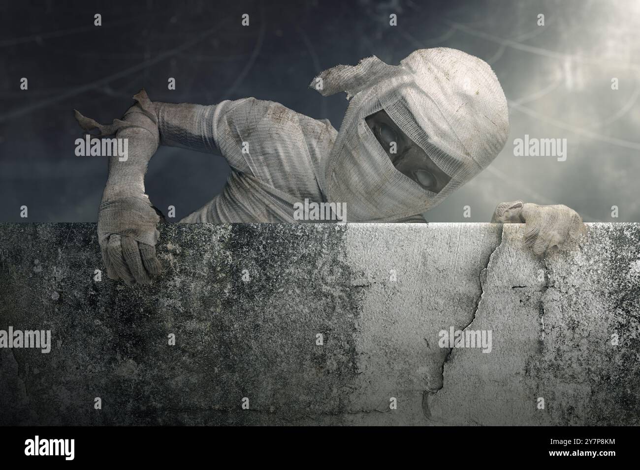 Mummy in bandages rising out of behind the wall, with a creepy, dark ...