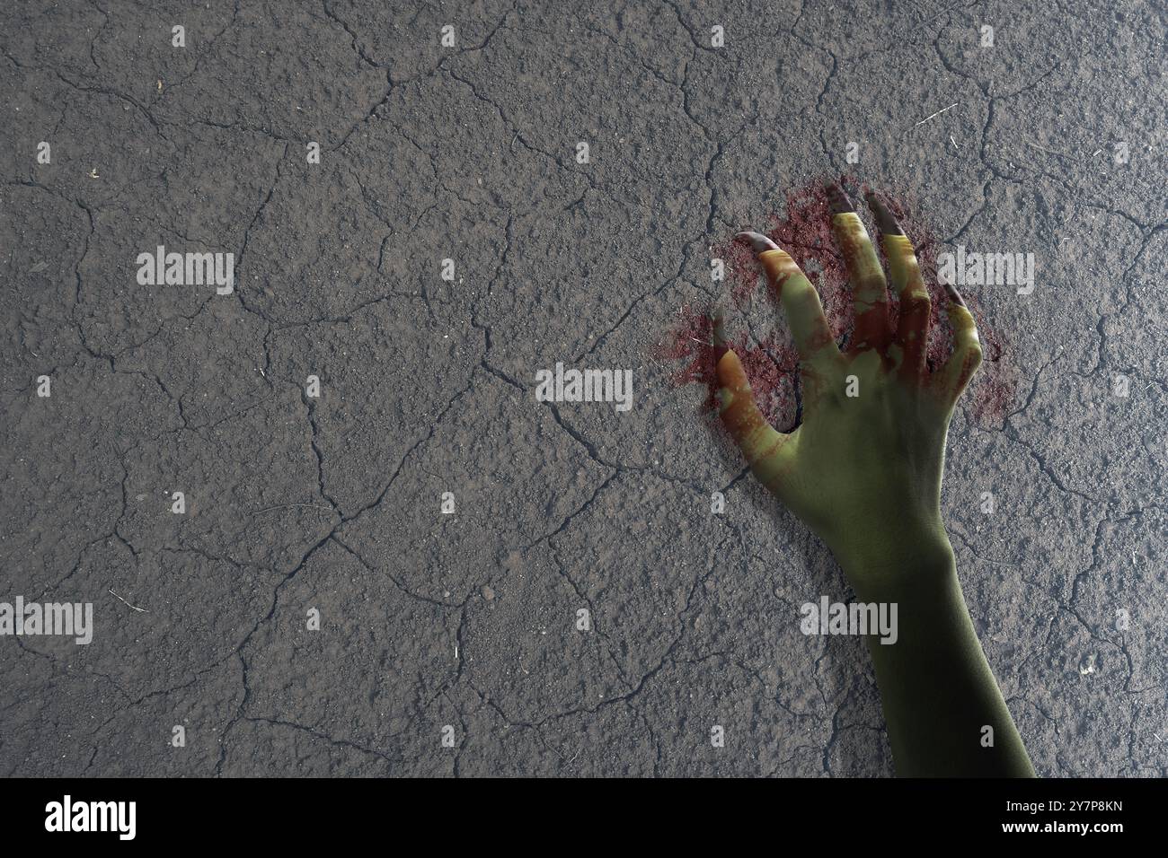 Witch hand with long nail claw is on a ground. The color hand is green ...