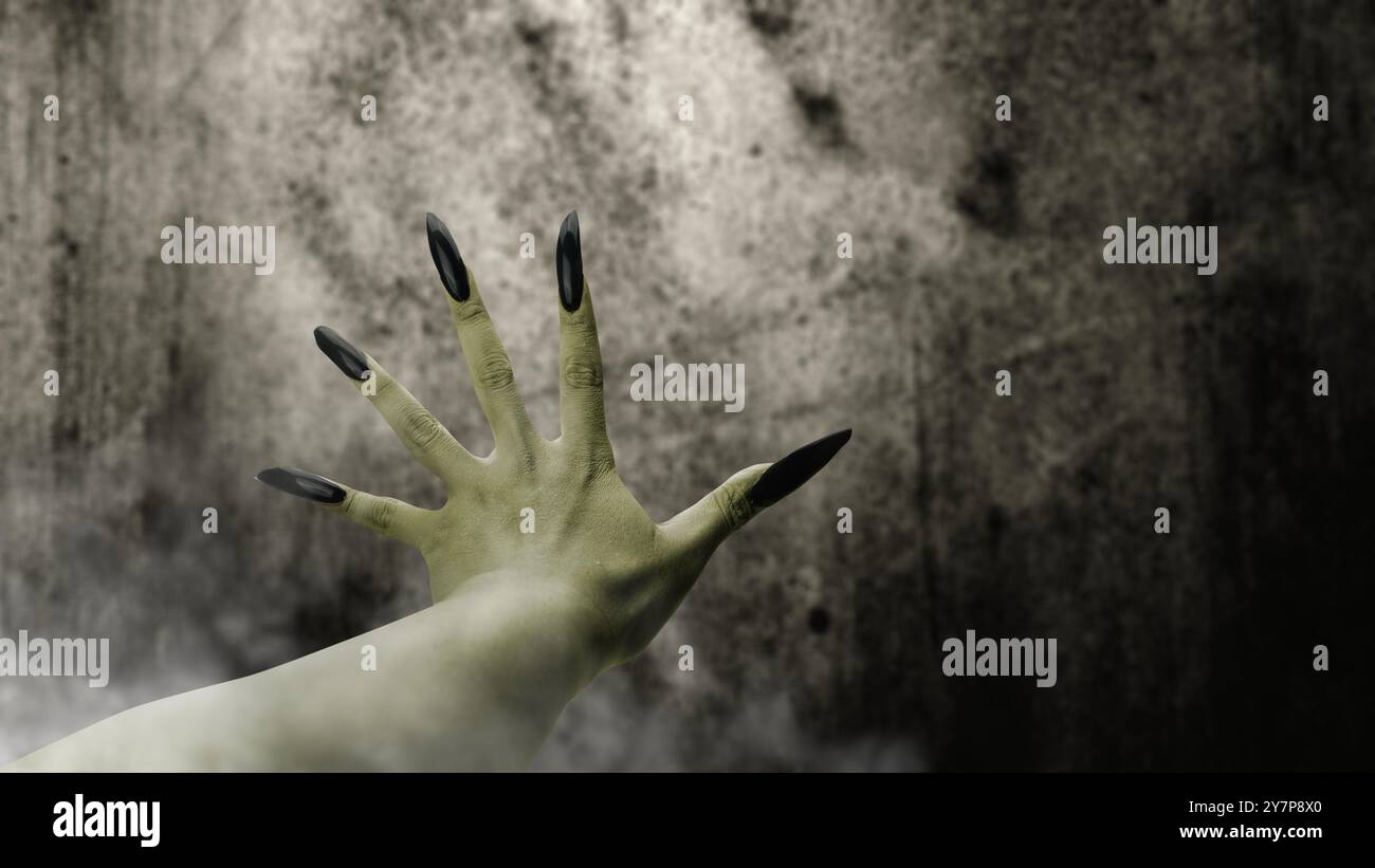 Witches hand with long nail claw is reaching out. The color is green ...