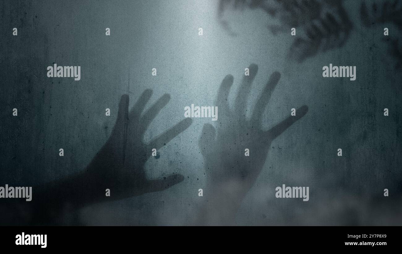 Shade of zombie hands on dark background. The hand appearing to be ...