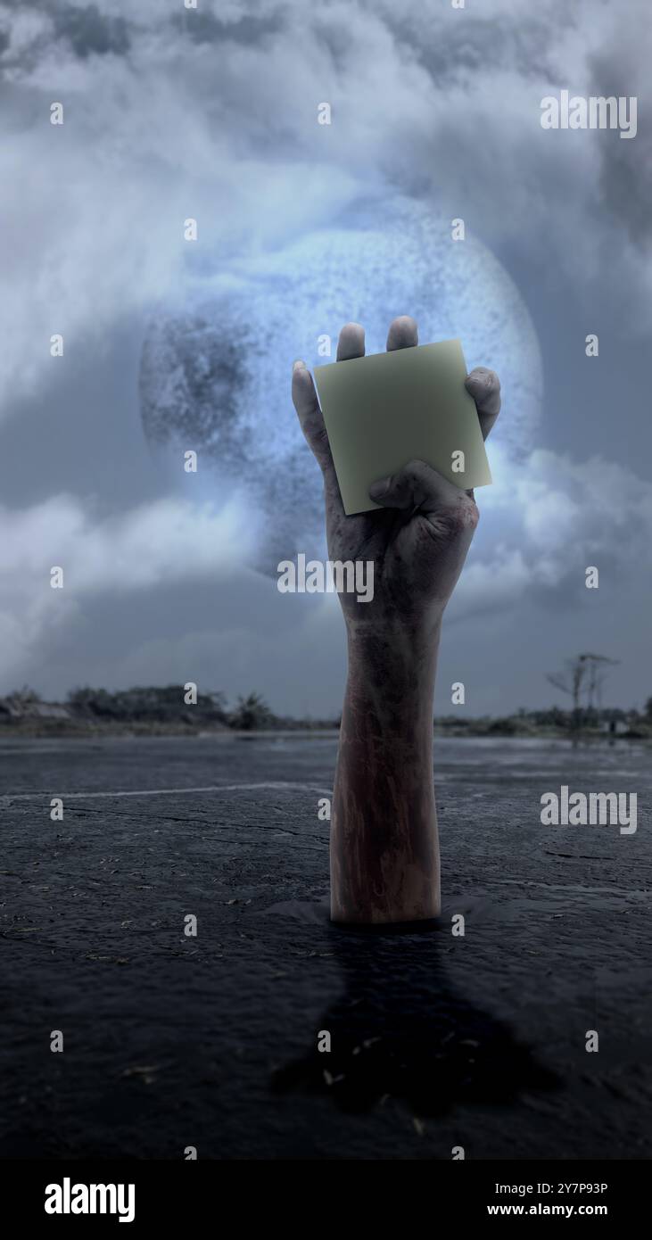 Zombie hand with bloody wound rising out of ground holding notes paper ...