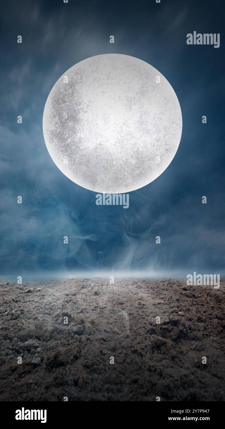 Large full moon in the sky above barren landscape. Scene is dark and ...