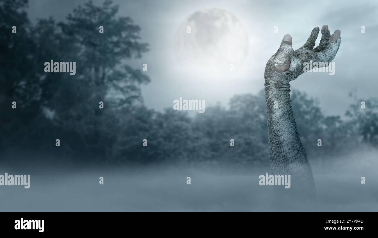 Mummy hand in bandages rising out of fog with a full moon in the ...