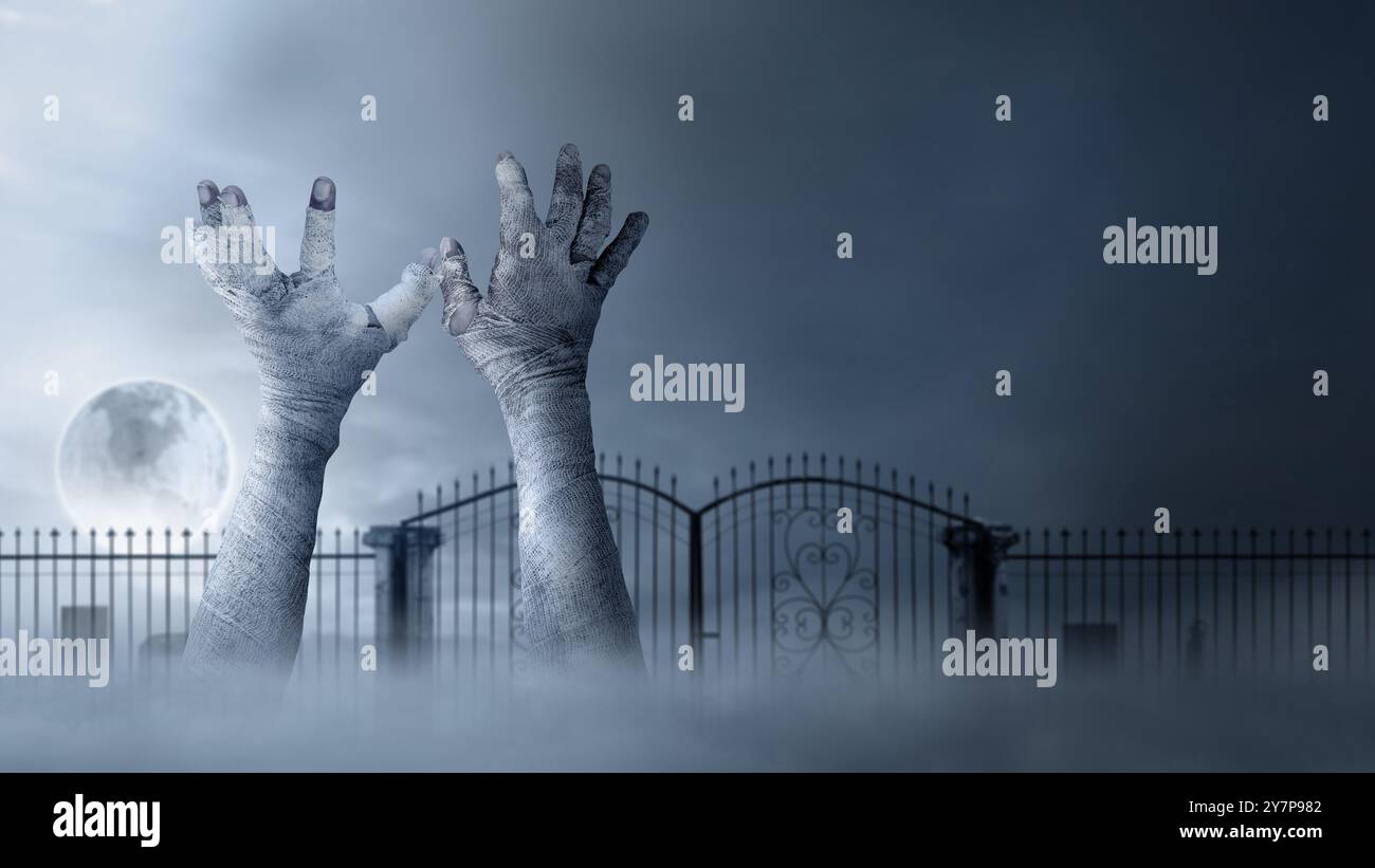 Mummy hands in bandages rising out of graveyard ground, with a creepy ...