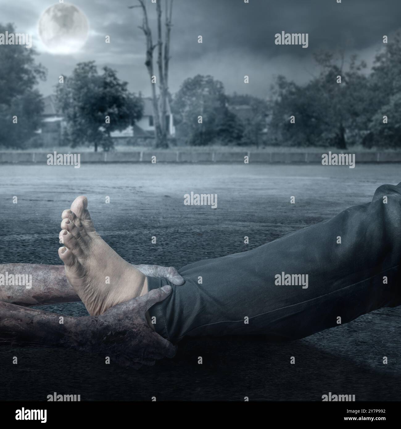 A zombie hand with a bloody wound grabs a human leg with full moon ...