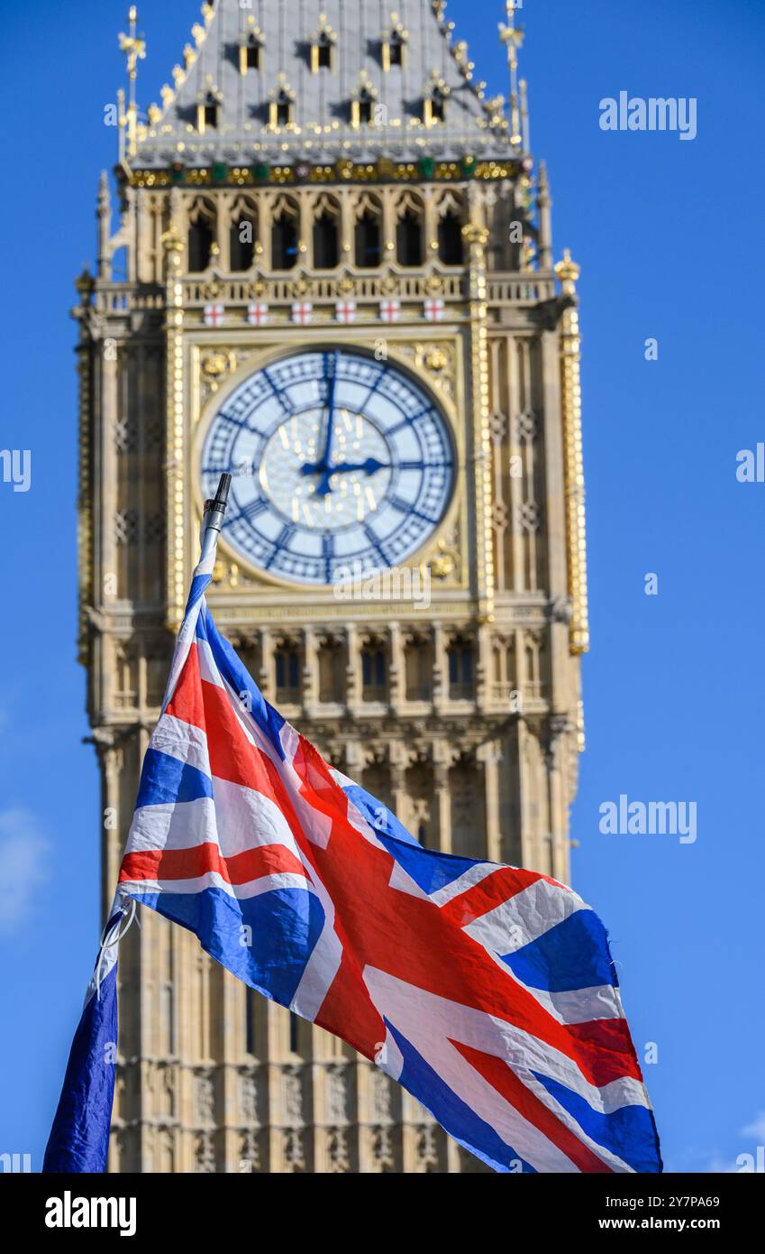 London, UK. Union Jack flag flying in front of Big Ben in Parliament ...