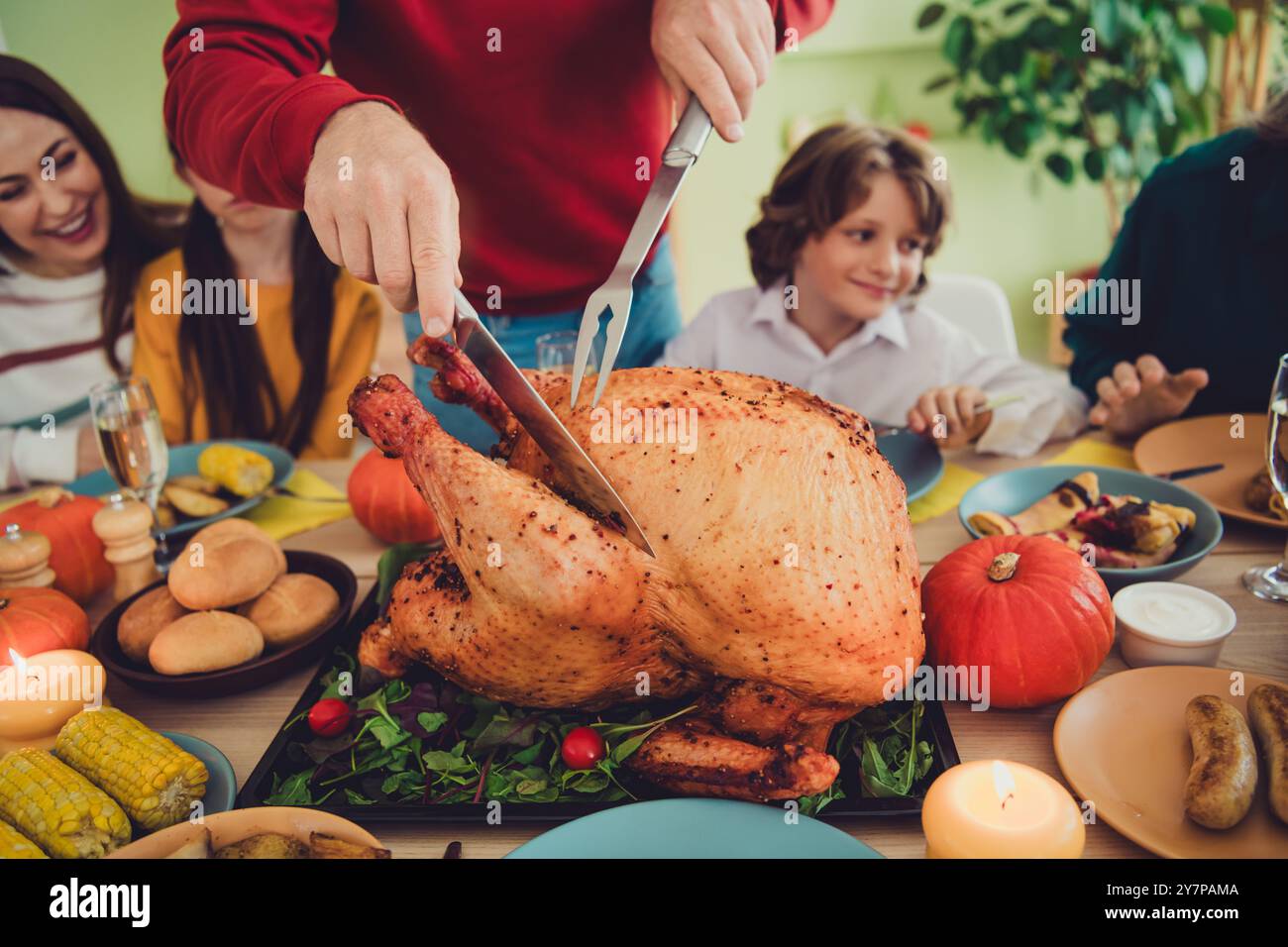 Photo of family celebrating thanksgiving day together man cutting ...