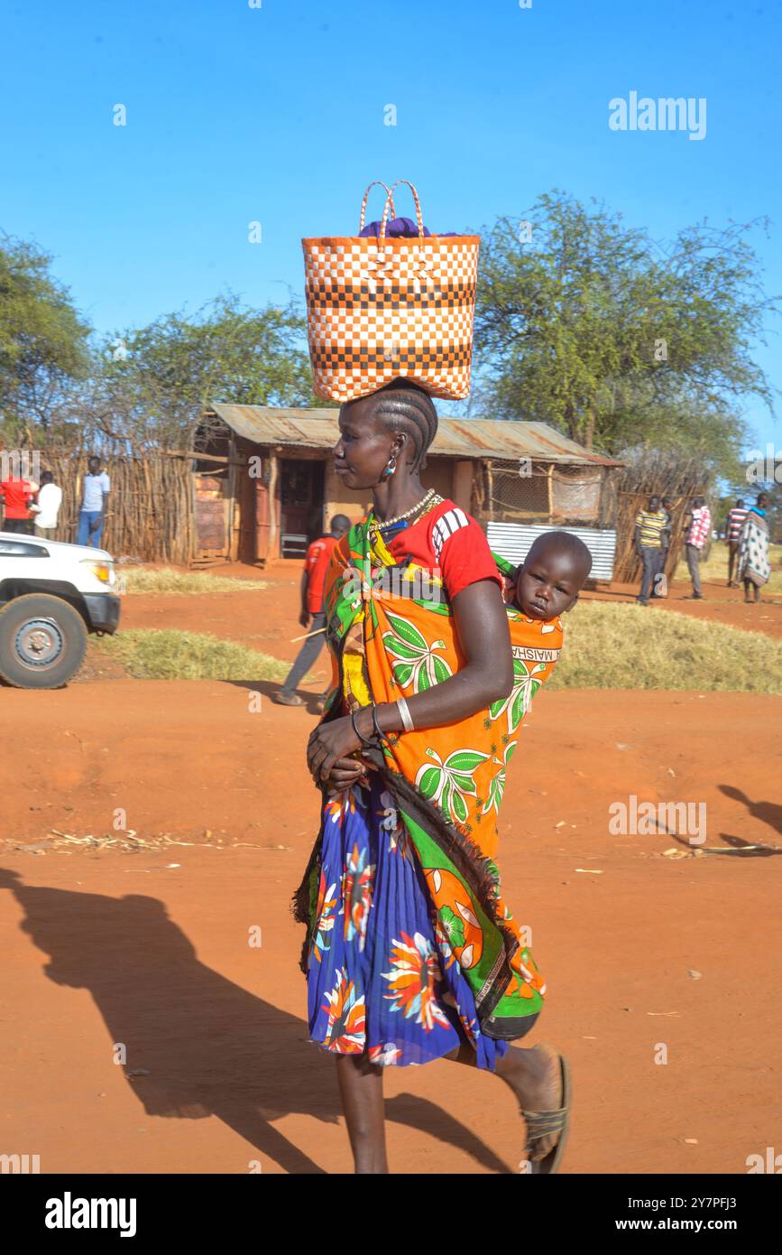 A Pokot woman walking with a bay on her back in Amudat - Karamoja Uganda Stock Photo - Alamy
