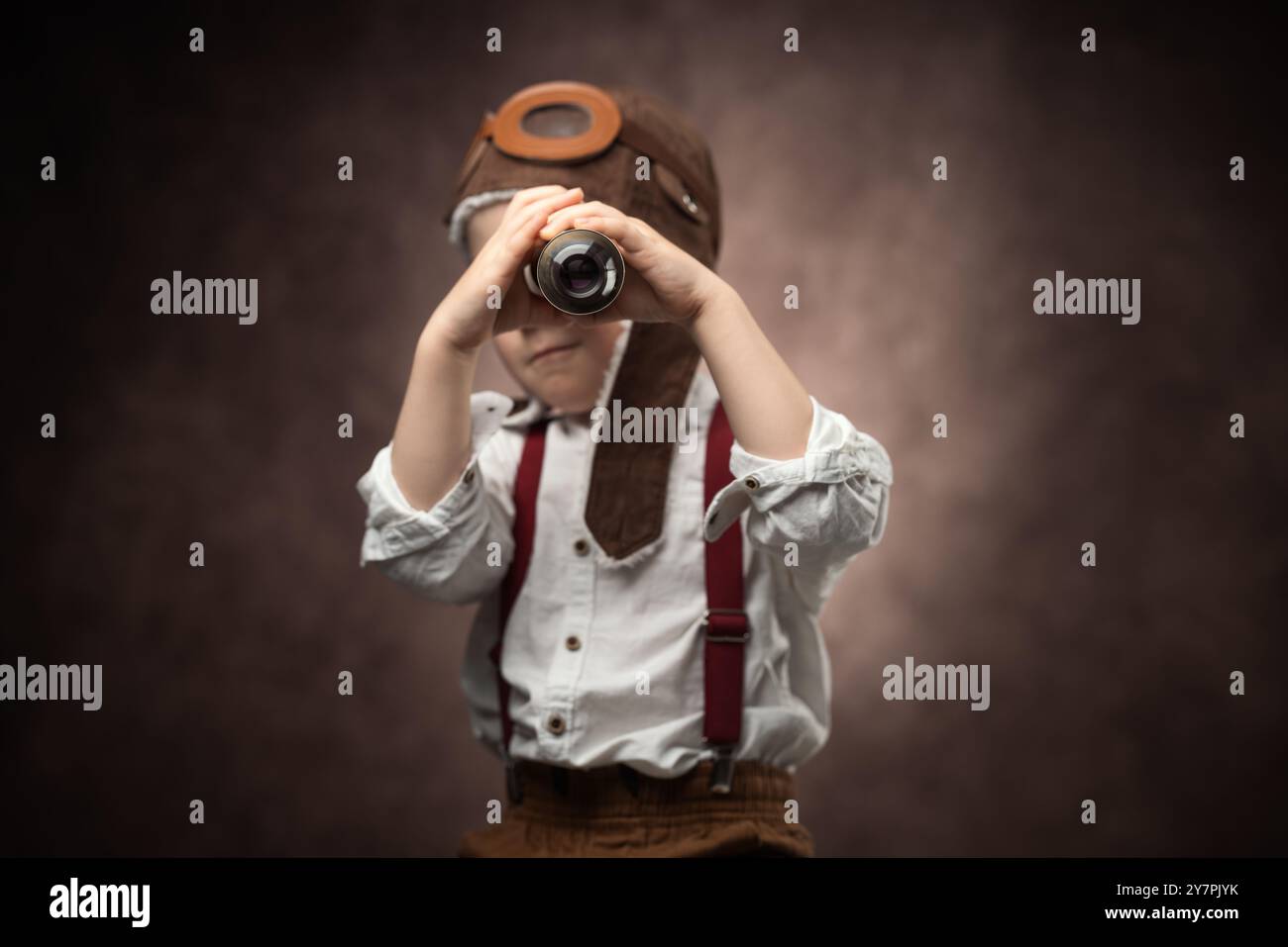 Child pilot with aviator cap and pirate monocular binoculars toy, retro ...