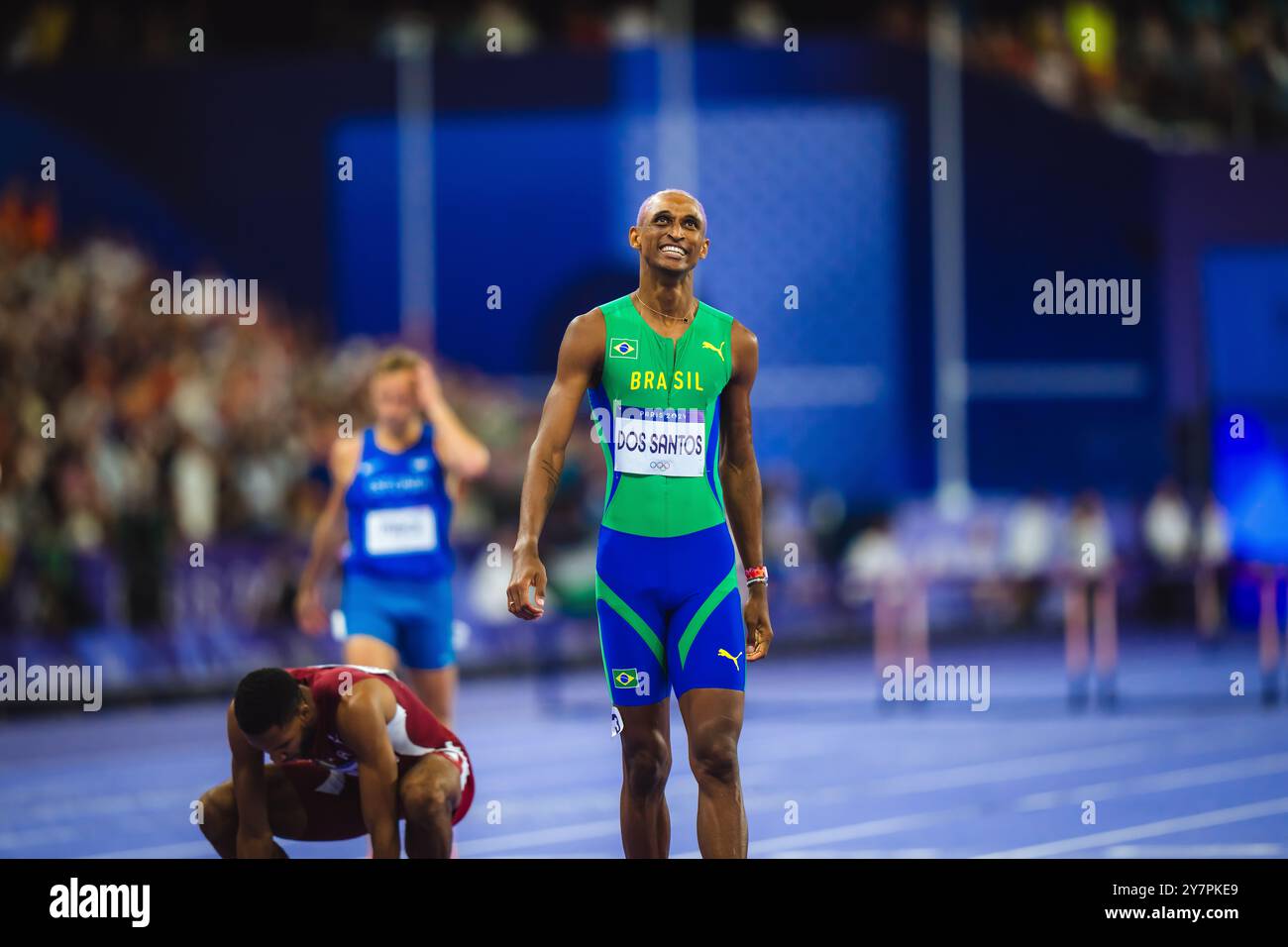 Alison dos Santos celebrating with her country's flag in the 400 meters ...