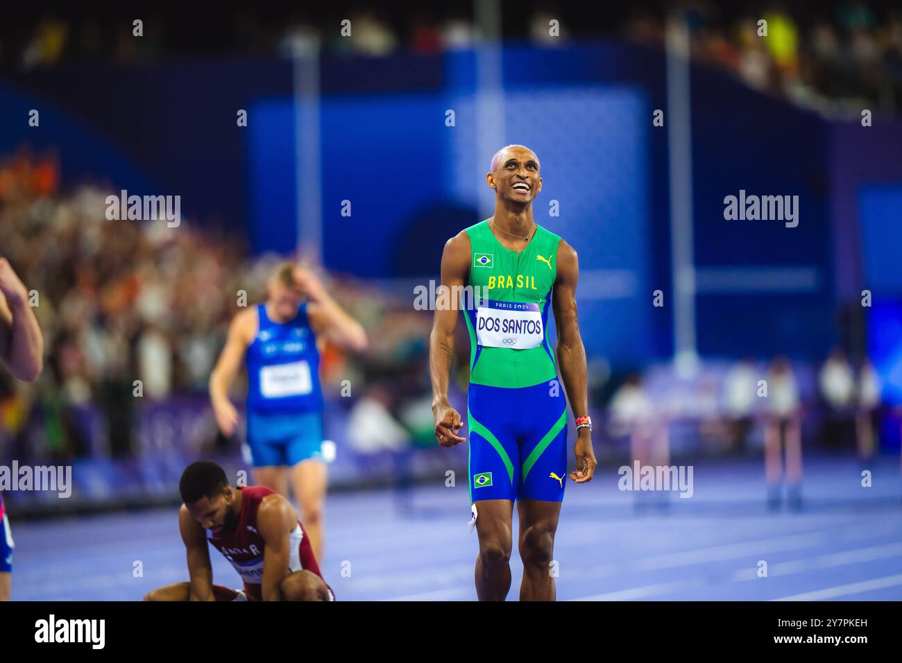 Alison dos Santos celebrating with her country's flag in the 400 meters ...