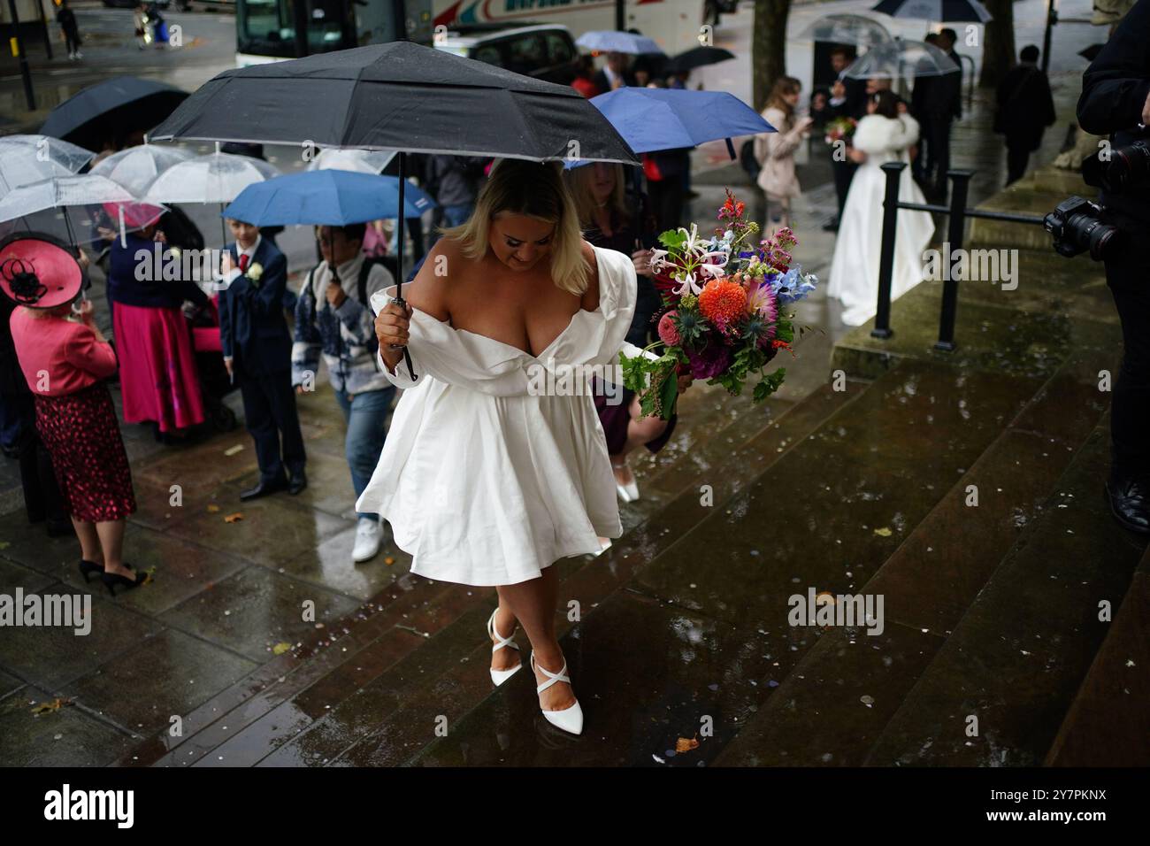 A bride arrives for her wedding at Old Marylebone Town Hall in London ...