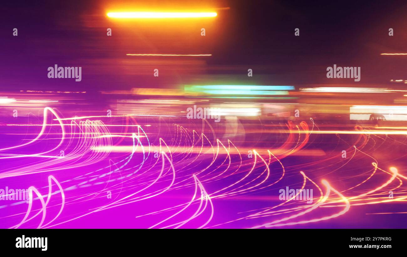 Long exposure light streaks of city lamps and vehicle traffic lights as ...