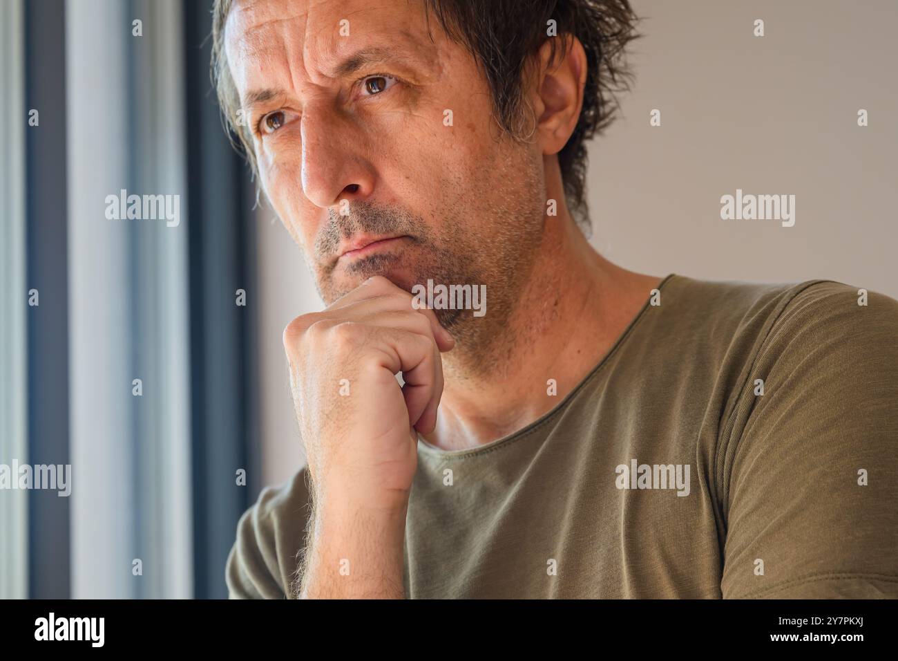 Headshot portrait of mature adult male thinking and looking out the ...