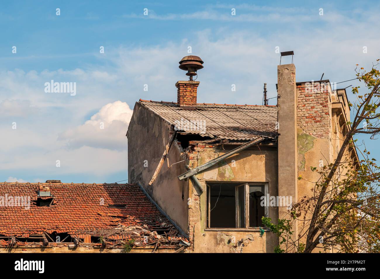 Old ruin, devastated house with asbestos roof tile ready to be rundown ...