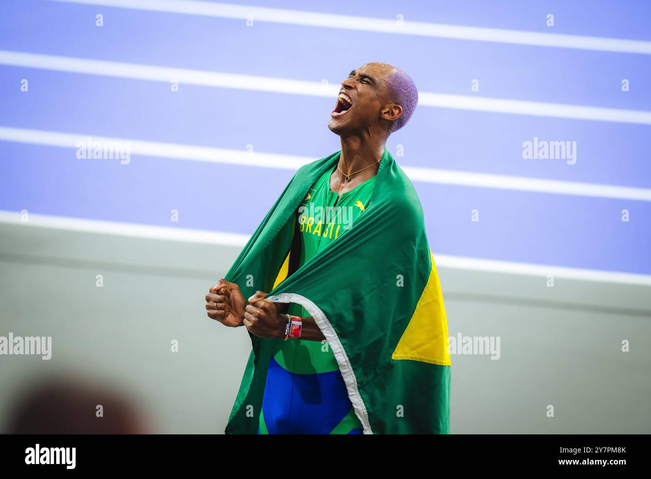 Alison dos Santos celebrating with her country's flag in the 400 meters ...