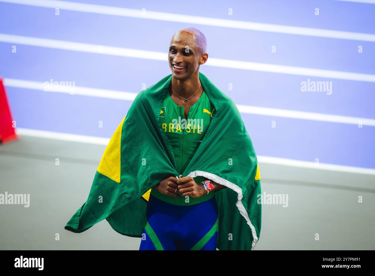 Alison dos Santos celebrating with her country's flag in the 400 meters ...