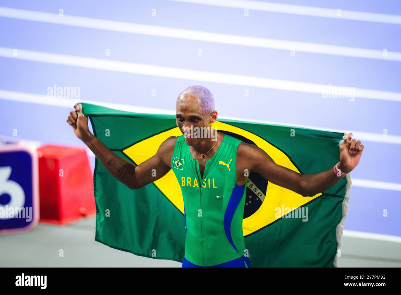 Alison dos Santos celebrating with her country's flag in the 400 meters ...