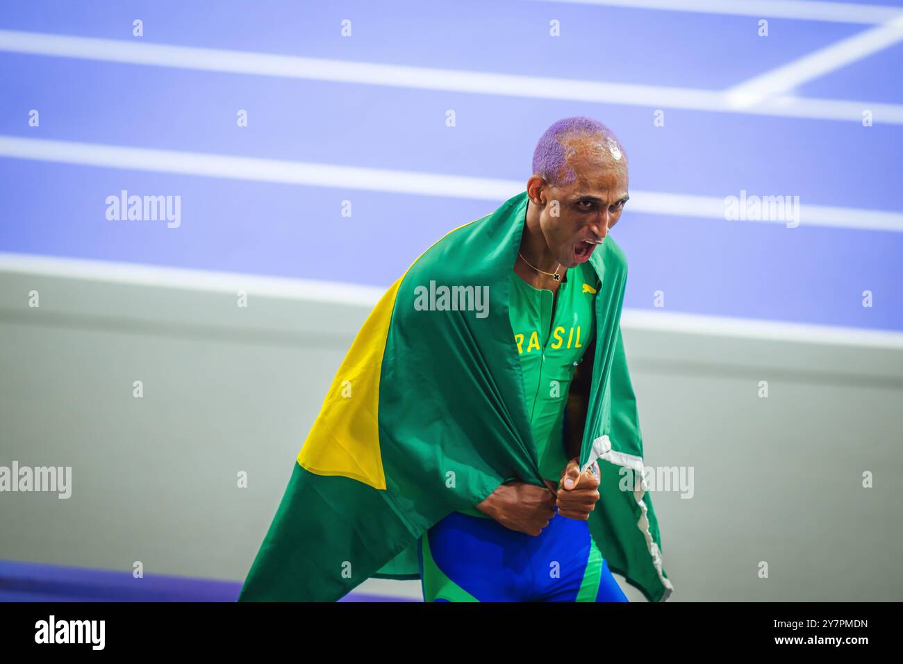 Alison dos Santos celebrating with her country's flag in the 400 meters ...