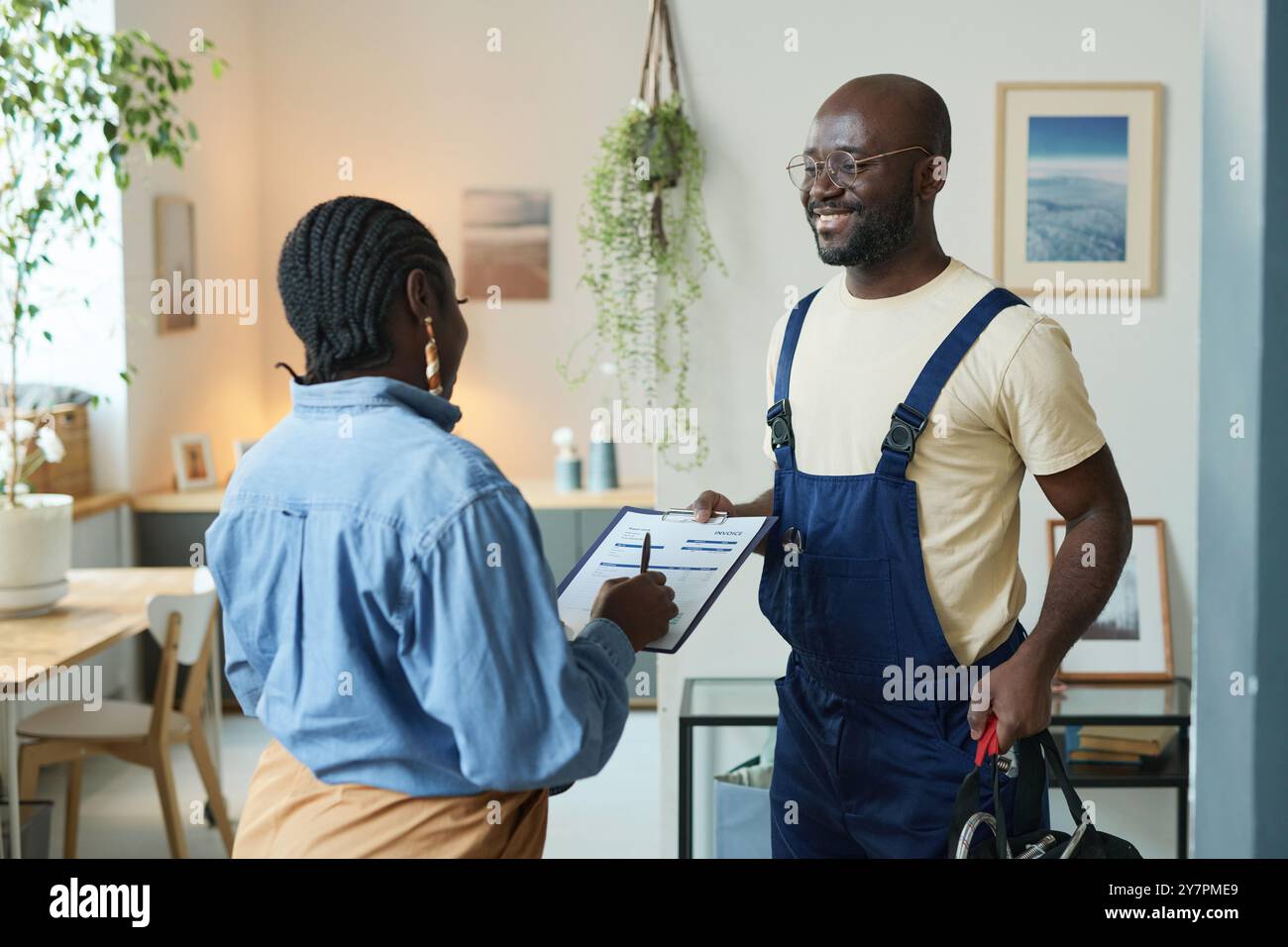 Worker Giving Contract to Client Stock Photo - Alamy