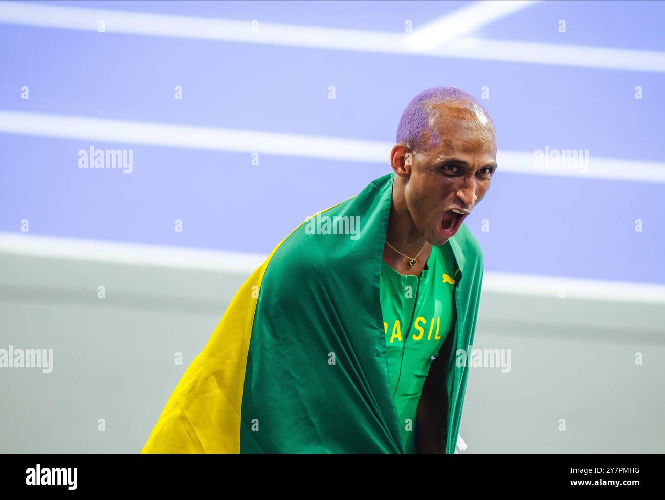 Alison dos Santos celebrating with her country's flag in the 400 meters ...