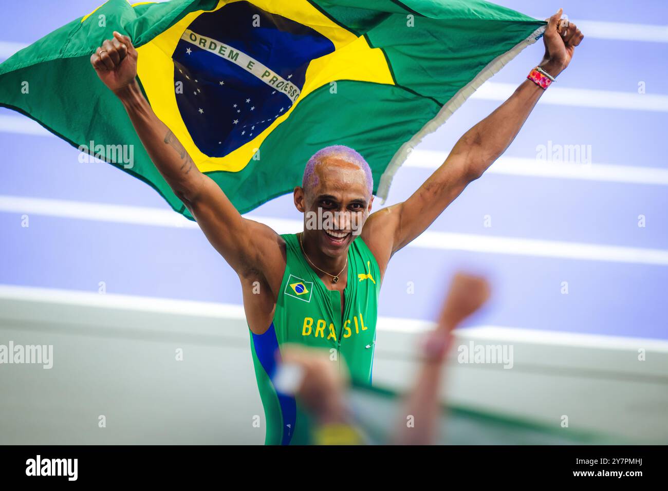 Alison dos Santos celebrating with her country's flag in the 400 meters ...