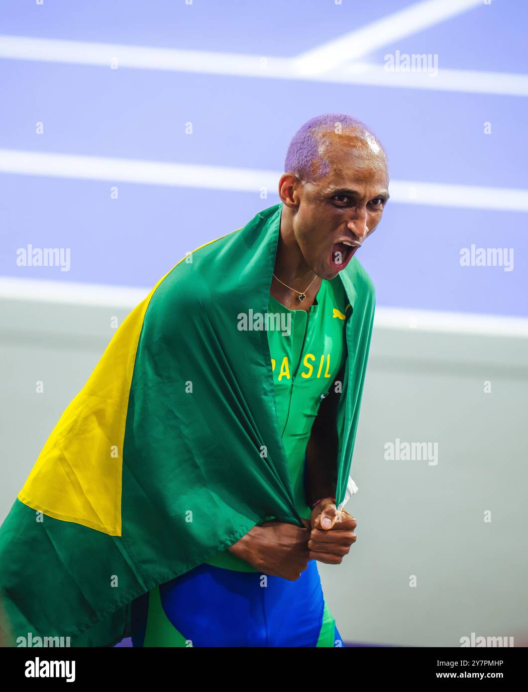 Alison dos Santos celebrating with her country's flag in the 400 meters ...