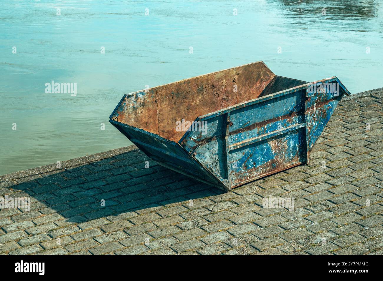 Old worn skip container on riverbank, selective focus Stock Photo - Alamy