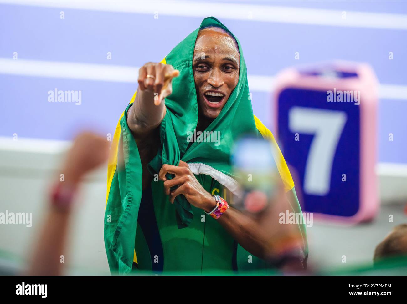 Alison dos Santos celebrating with her country's flag in the 400 meters ...