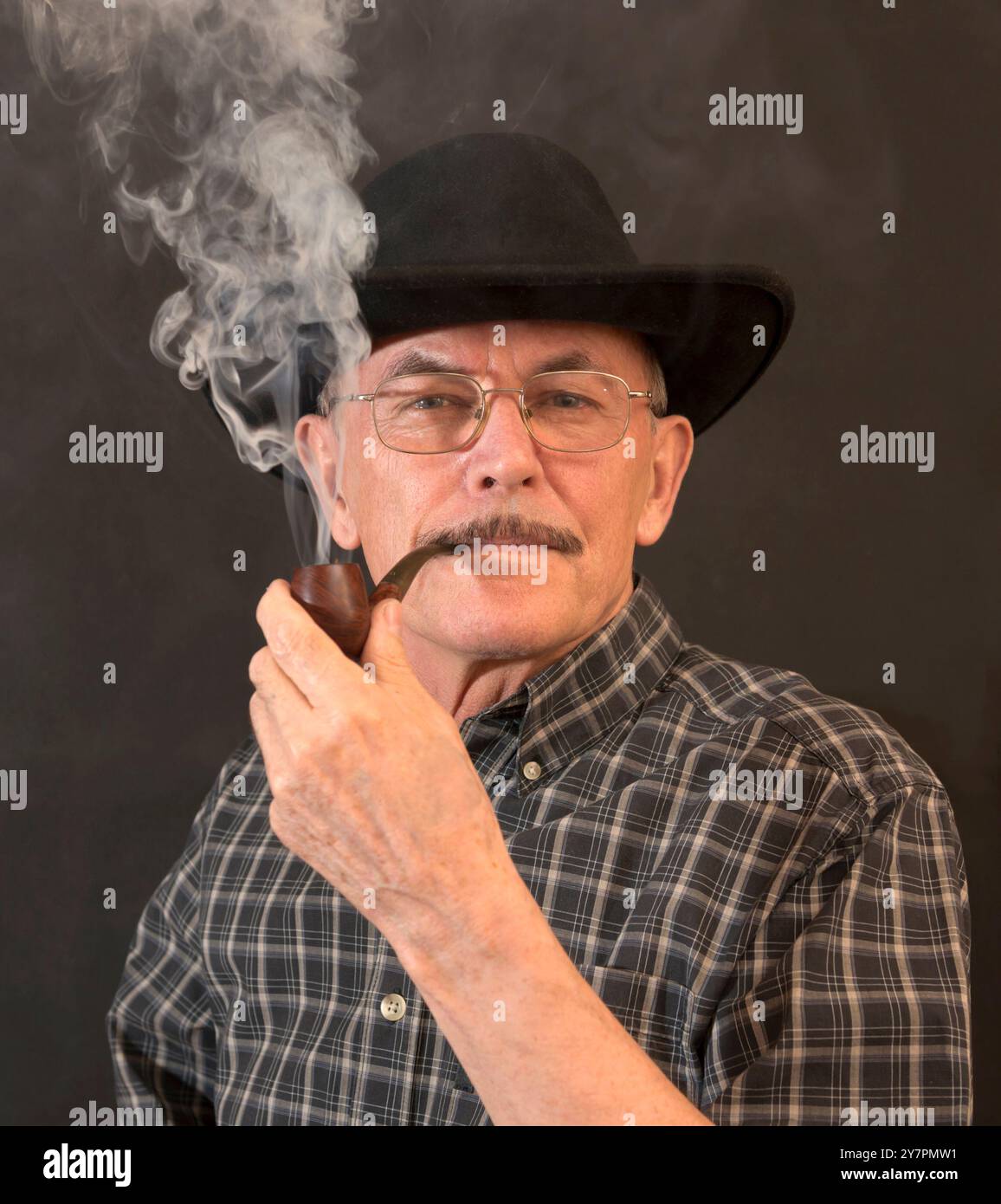 Cowboy in hat with Pipe Stock Photo - Alamy