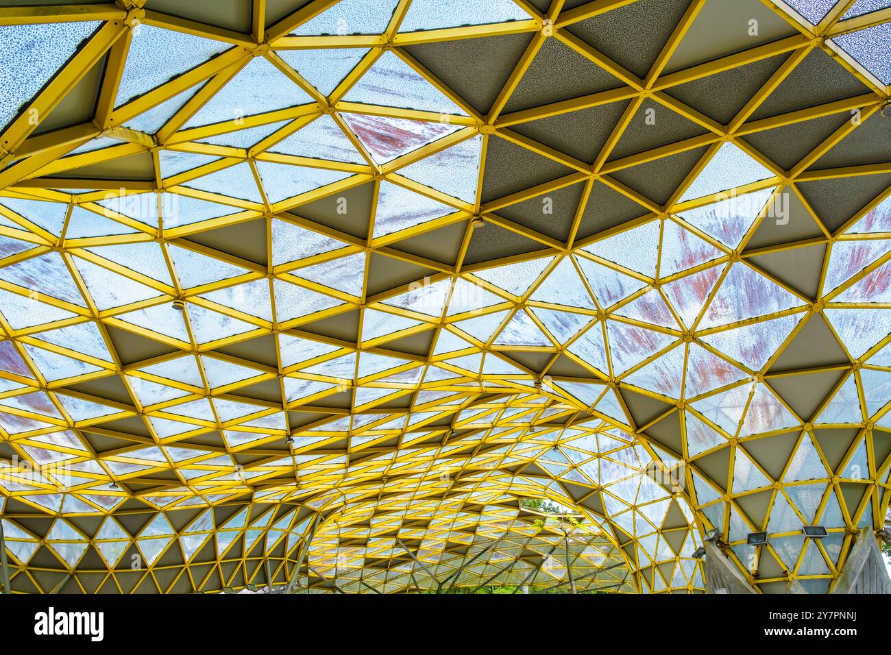 Modern geometric yellow lattice roof structure with a repetitive ...