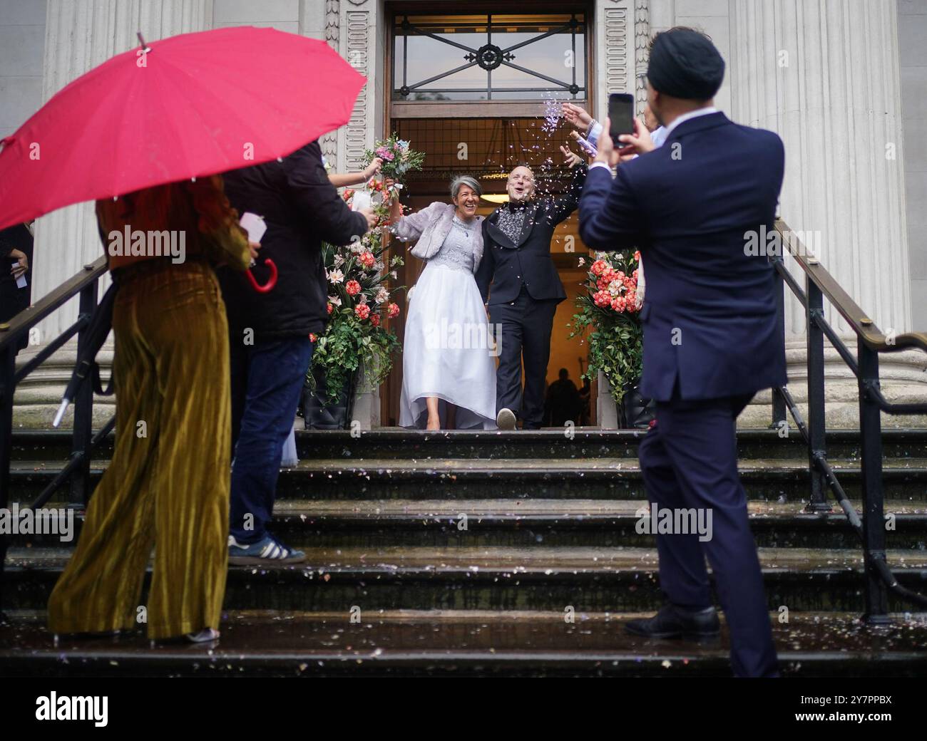 Ian Elliot, 54, and Paula Diaz, 50, following their civil partnership ...