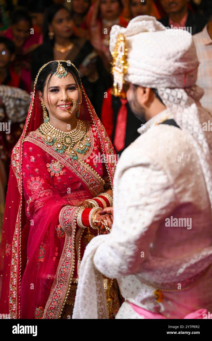 An Indian bride and groom in traditional attire during wedding ceremony ...