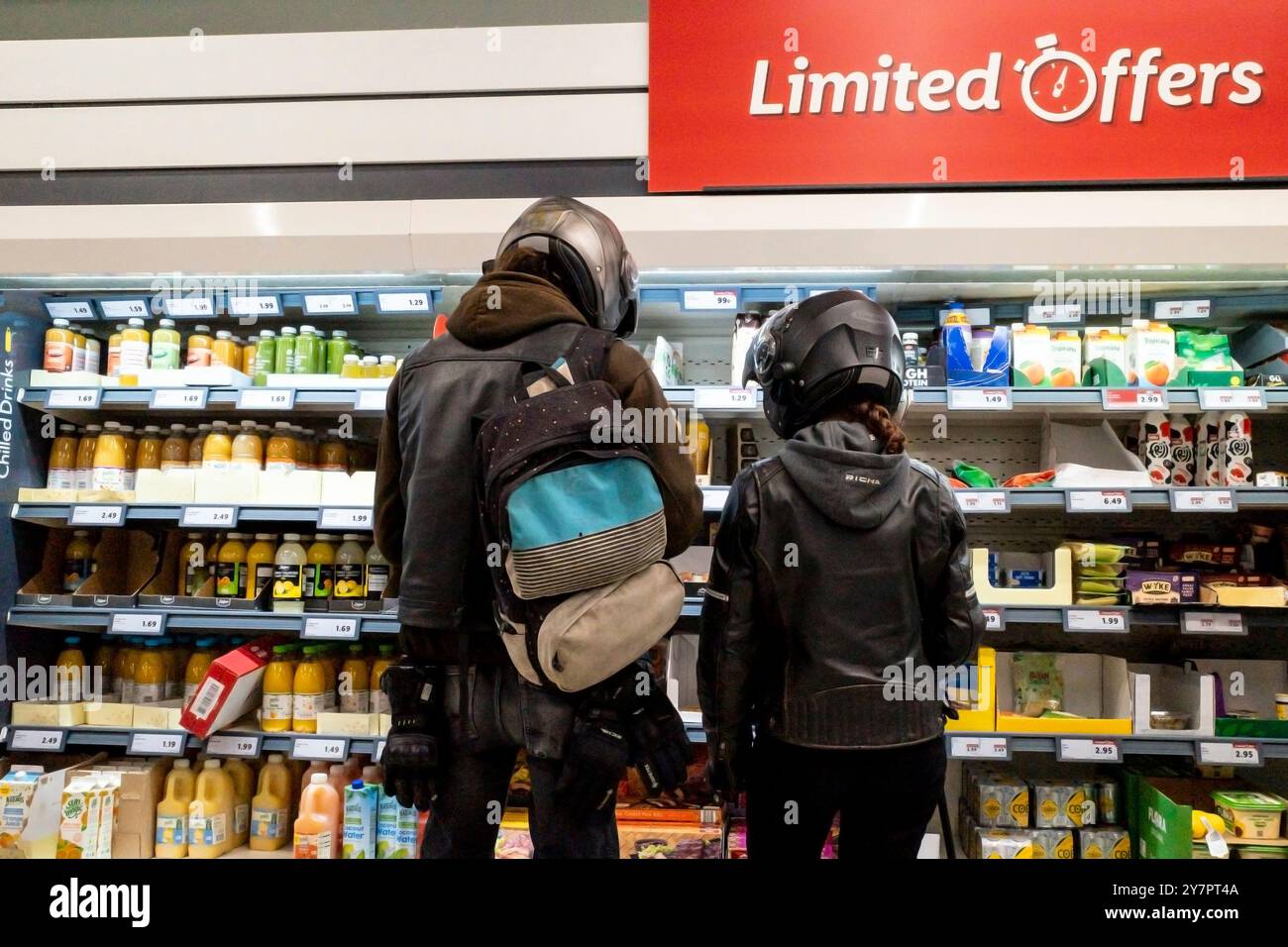Two shoppers customers people wearing crash helmets people shopping ...