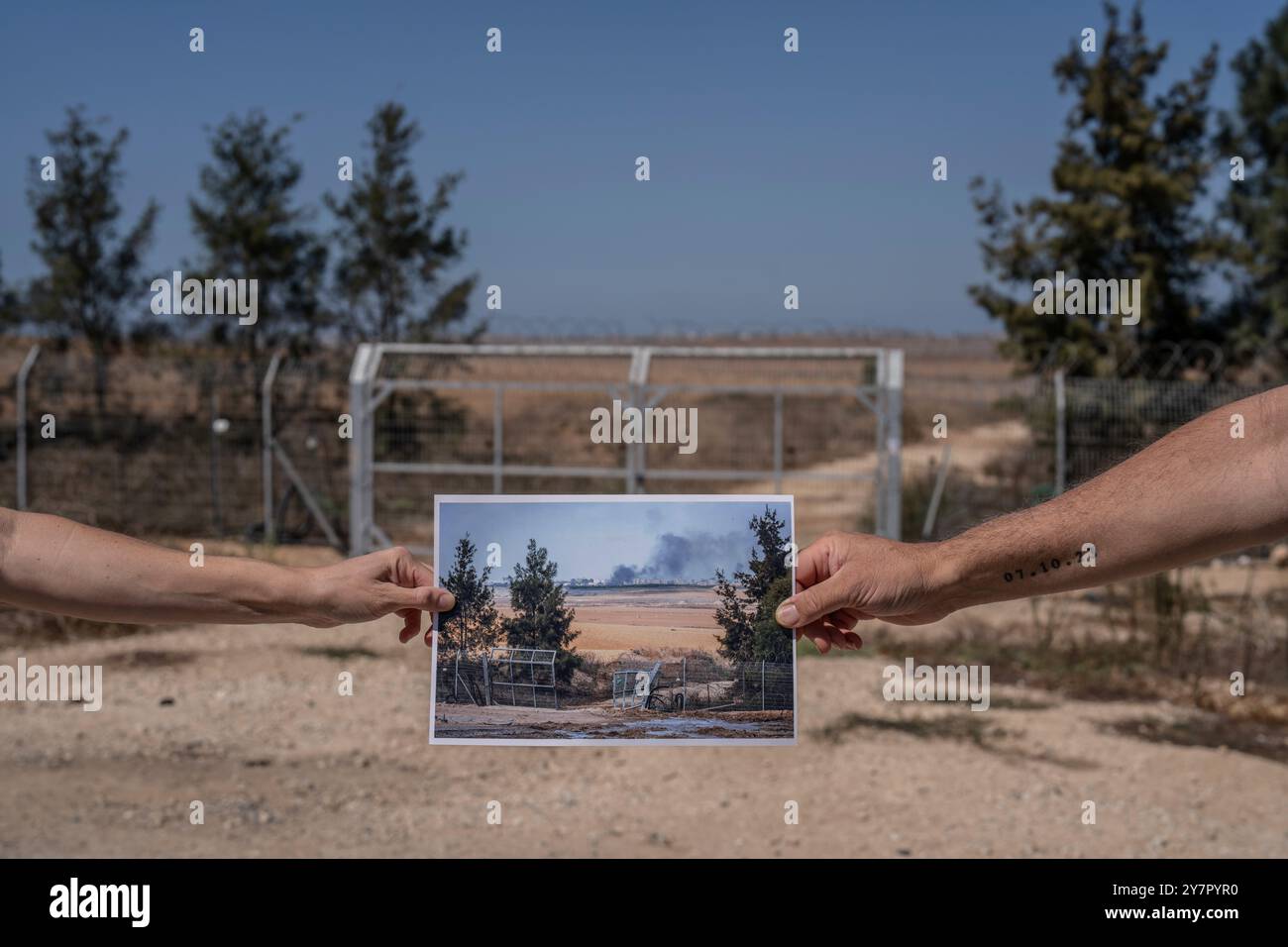 26 September 2024, Israel, Kfar Aza: A picture shows people holding a ...