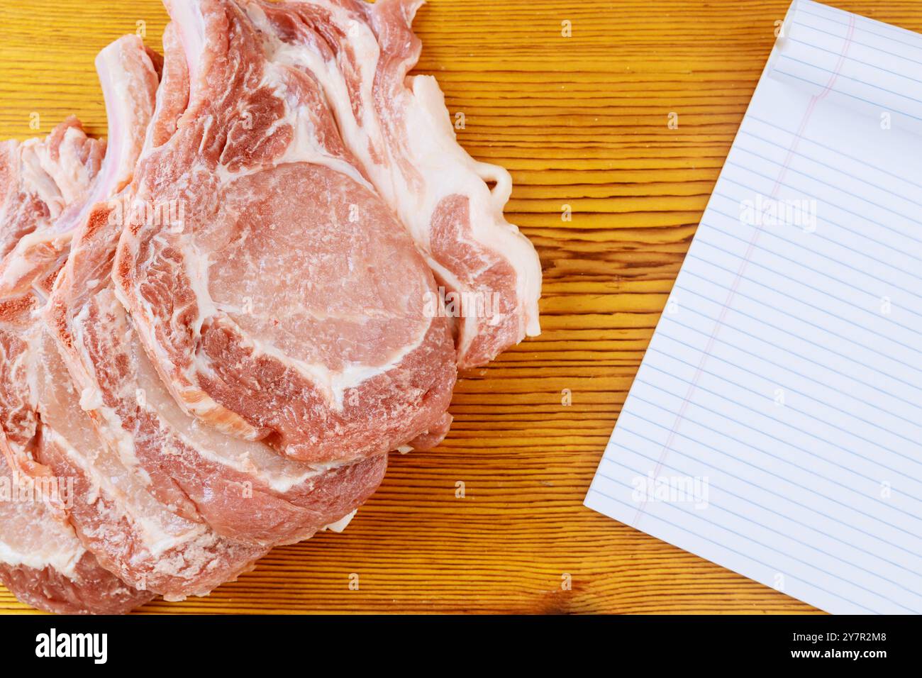 Fresh meat portion pieces steaks of raw pork in row ready to marinade ...