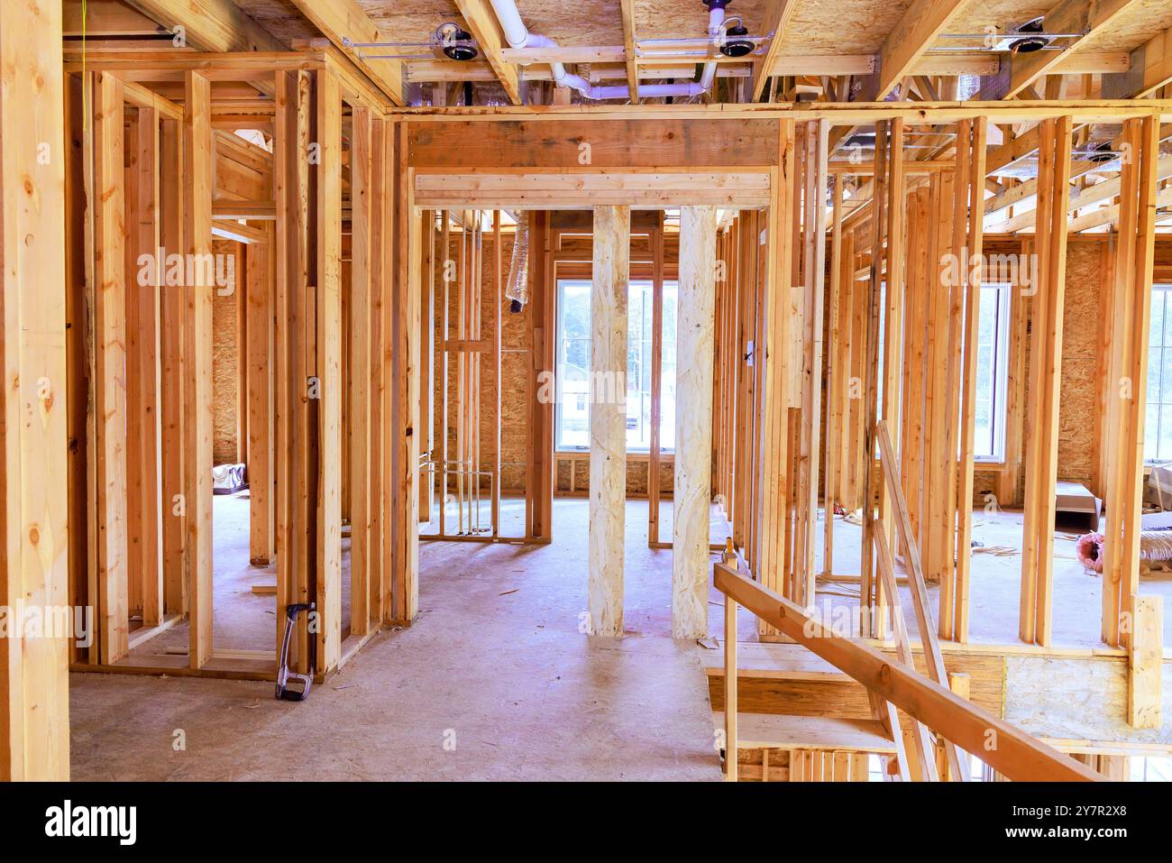 Beam is supported by wooden stud timber framing in interior of newly ...